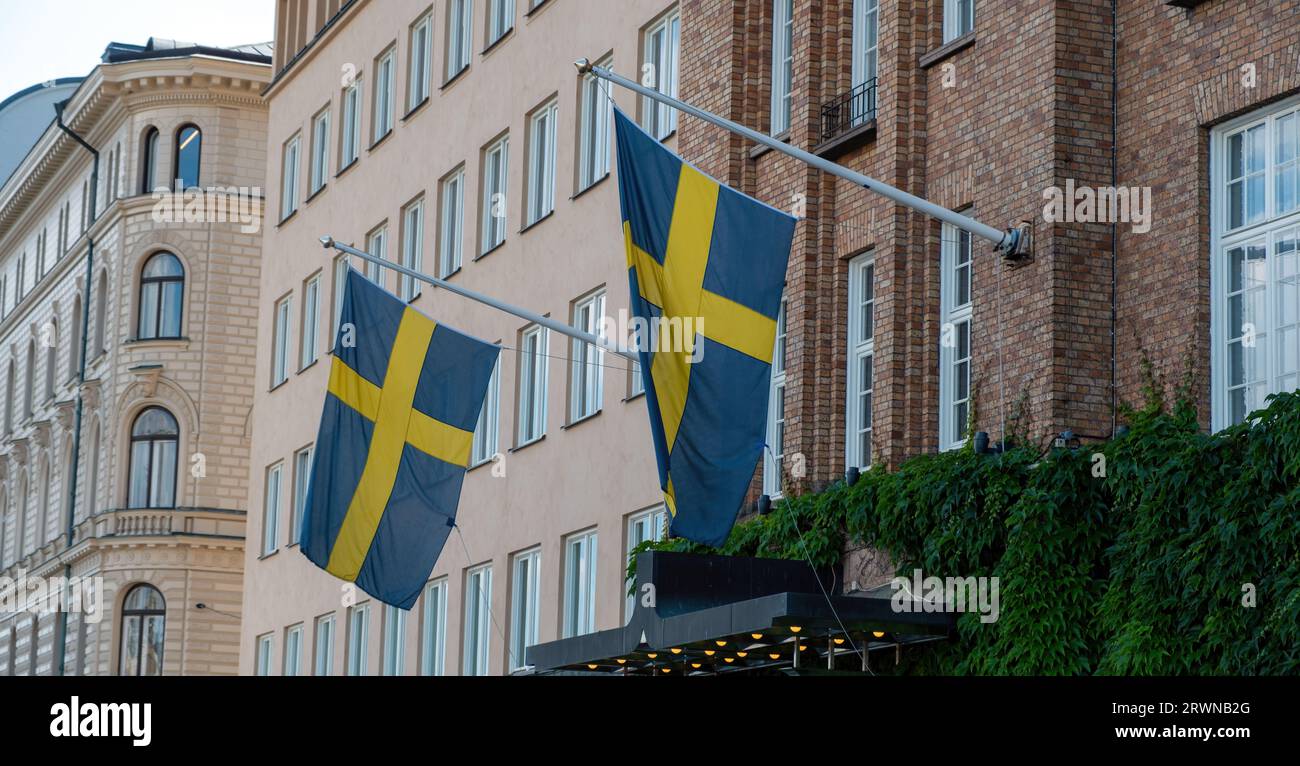 Sweden national flags waving on a Stockholm city building facade, close ...