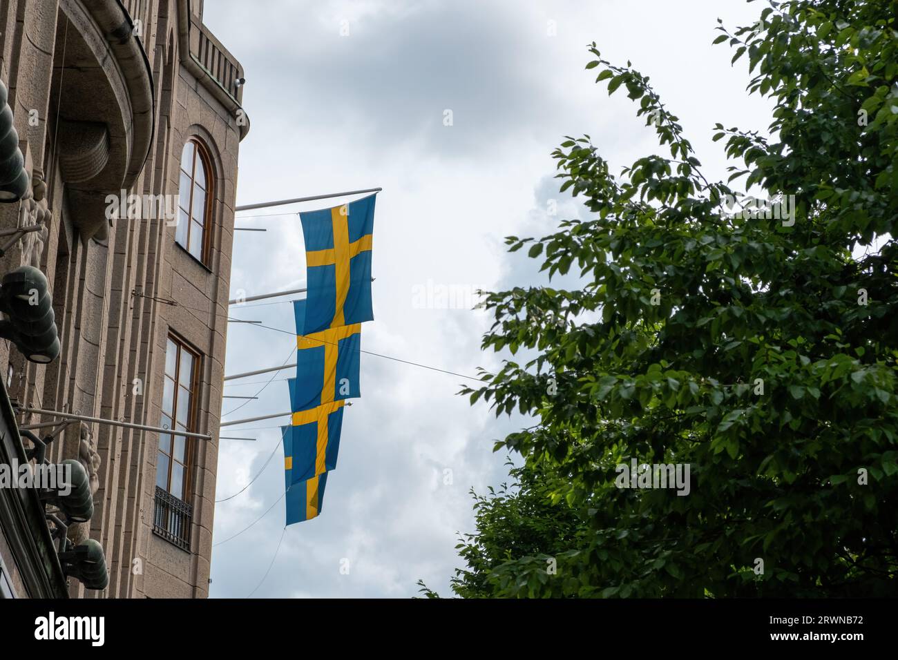 Sweden national flags waving on a Stockholm city building facade ...