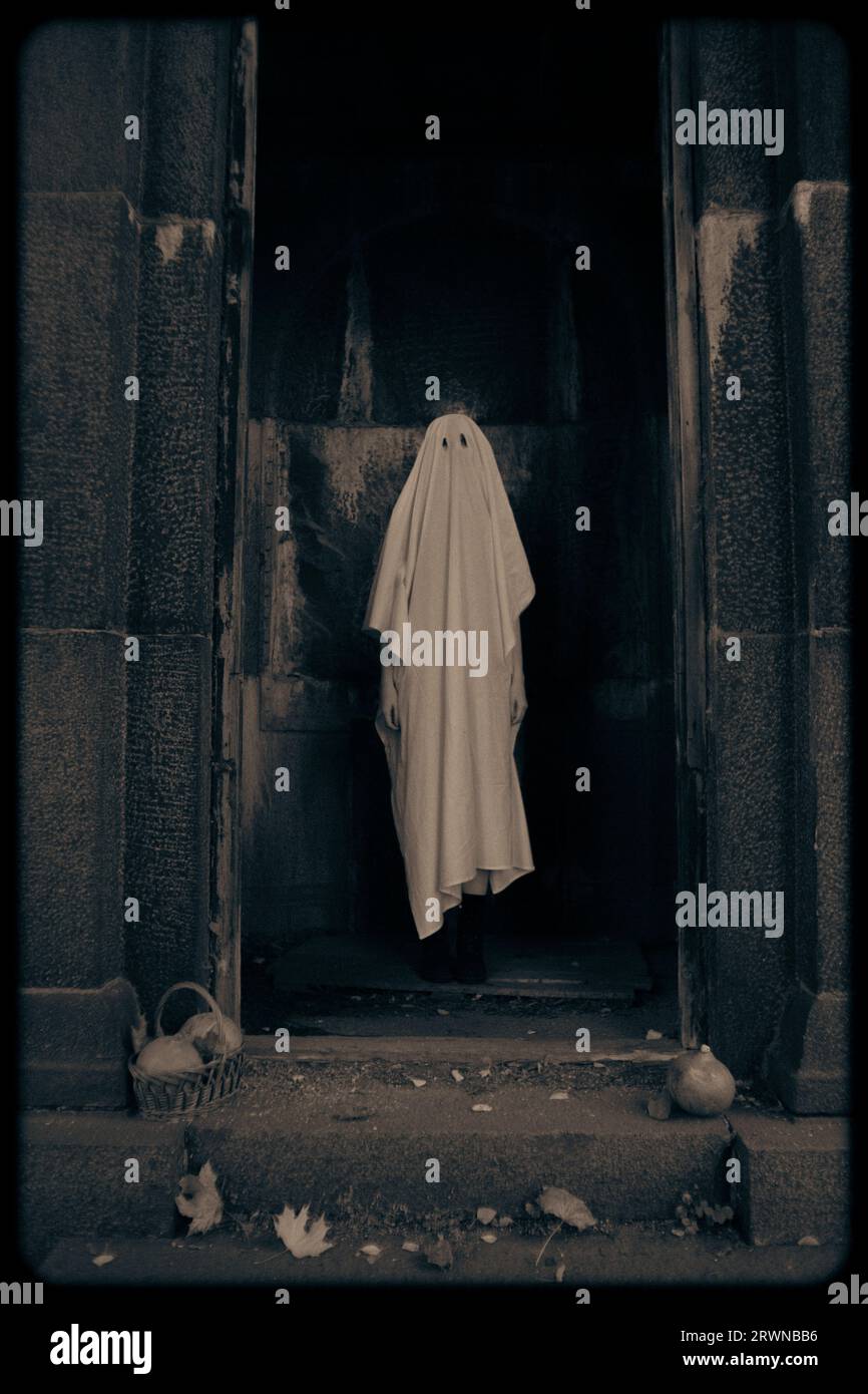 A ghost standing in a crypt amongst pumpkins and autumn leaves ...