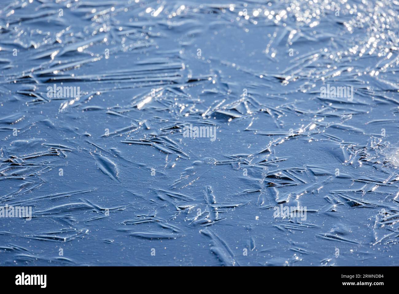 Thin ice surface on a frozen lake, natural background photo with ...