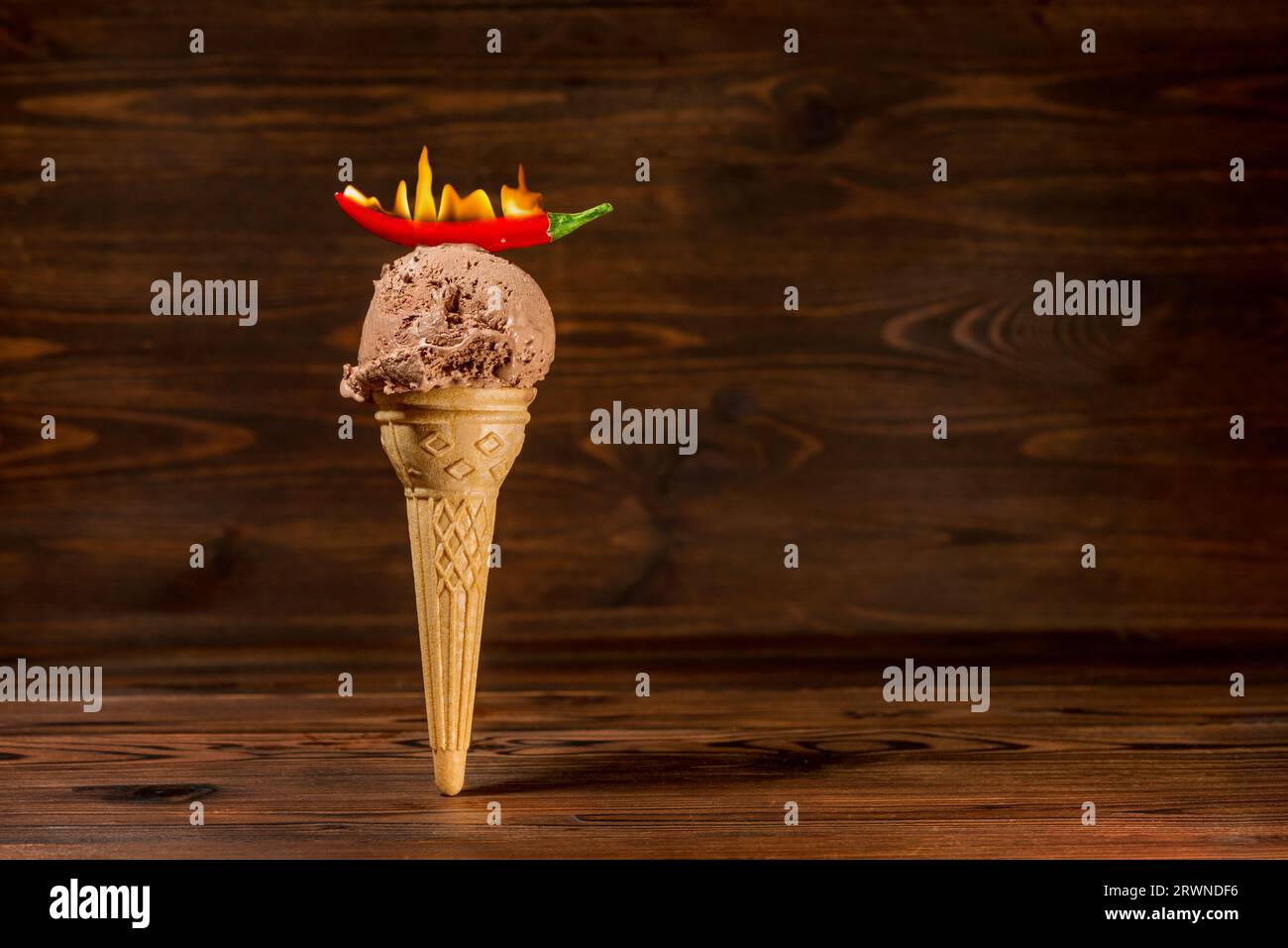 funny creative concept of unstable wafer cone with scoop of chocolate ...