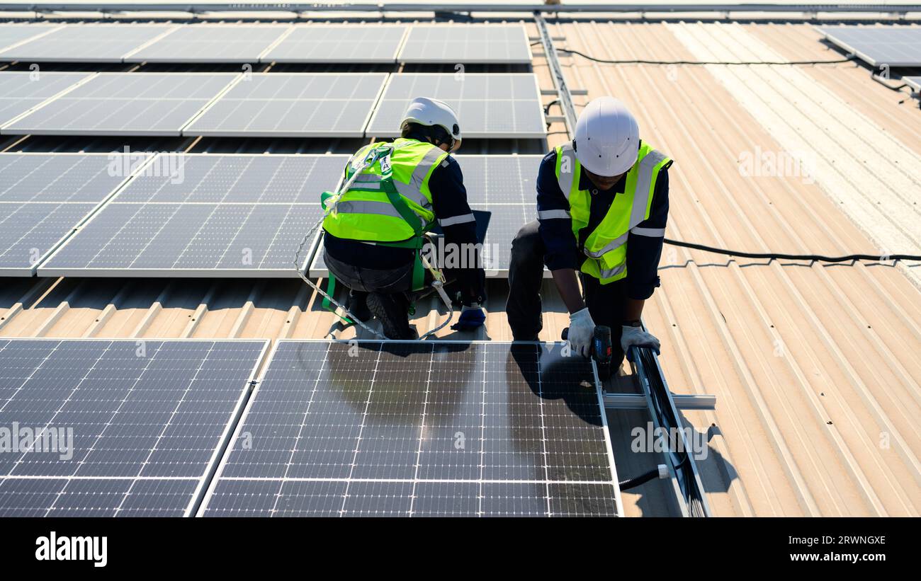 Engineers with safety helmet checking solar system at solar power farm ...