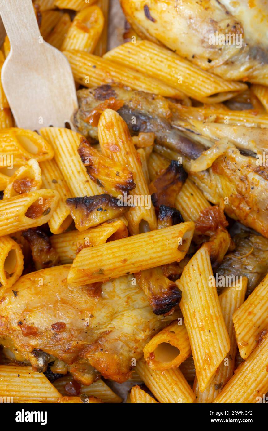 Penne pasta with chicken in a tomato and herb sauce takeaway in a ...