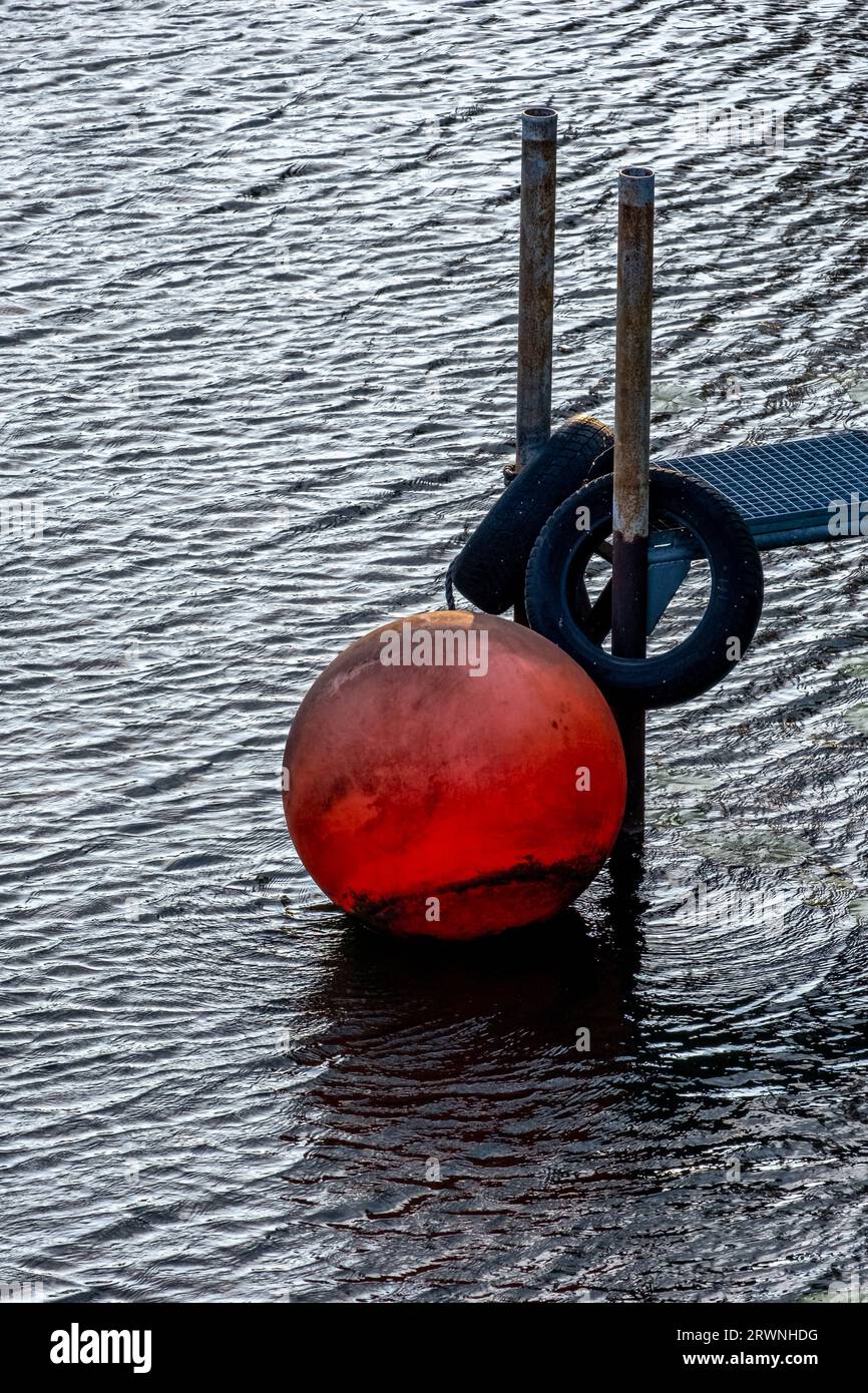 Close-up of a red plastic ball on a boat dock Stock Photo - Alamy