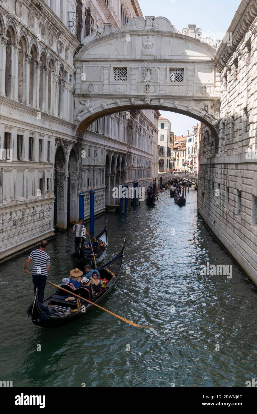 A gondolier with his familiar black and white striped shirt is a rower ...