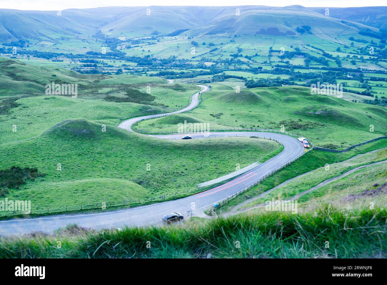 early evening traffic on road at Peak District National Park Derbyshire ...
