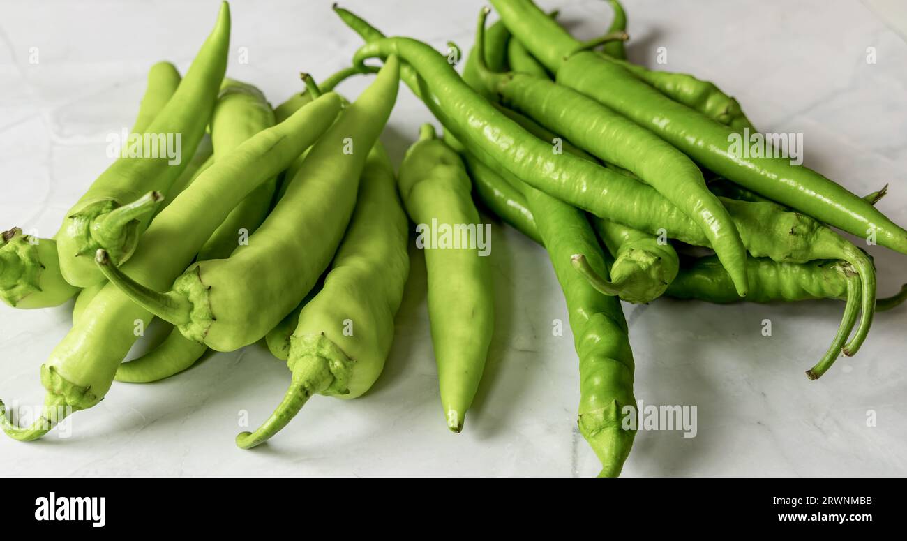 A bunch of green pepper pods. Hot chili pepper Stock Photo - Alamy