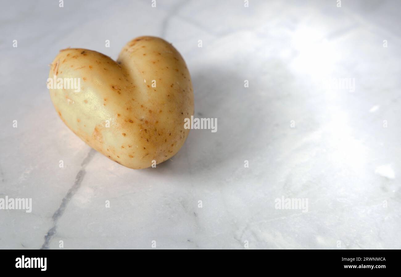 Heart shaped potatoes. A bunch of fresh potatoes Stock Photo - Alamy