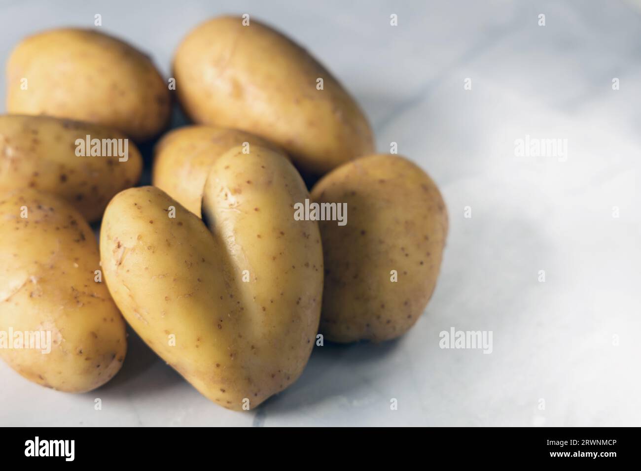 Heart shaped potatoes. A bunch of fresh potatoes Stock Photo - Alamy