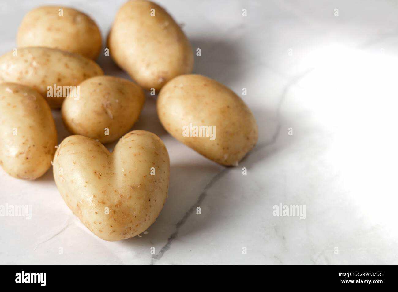 Heart shaped potatoes. A bunch of fresh potatoes Stock Photo - Alamy