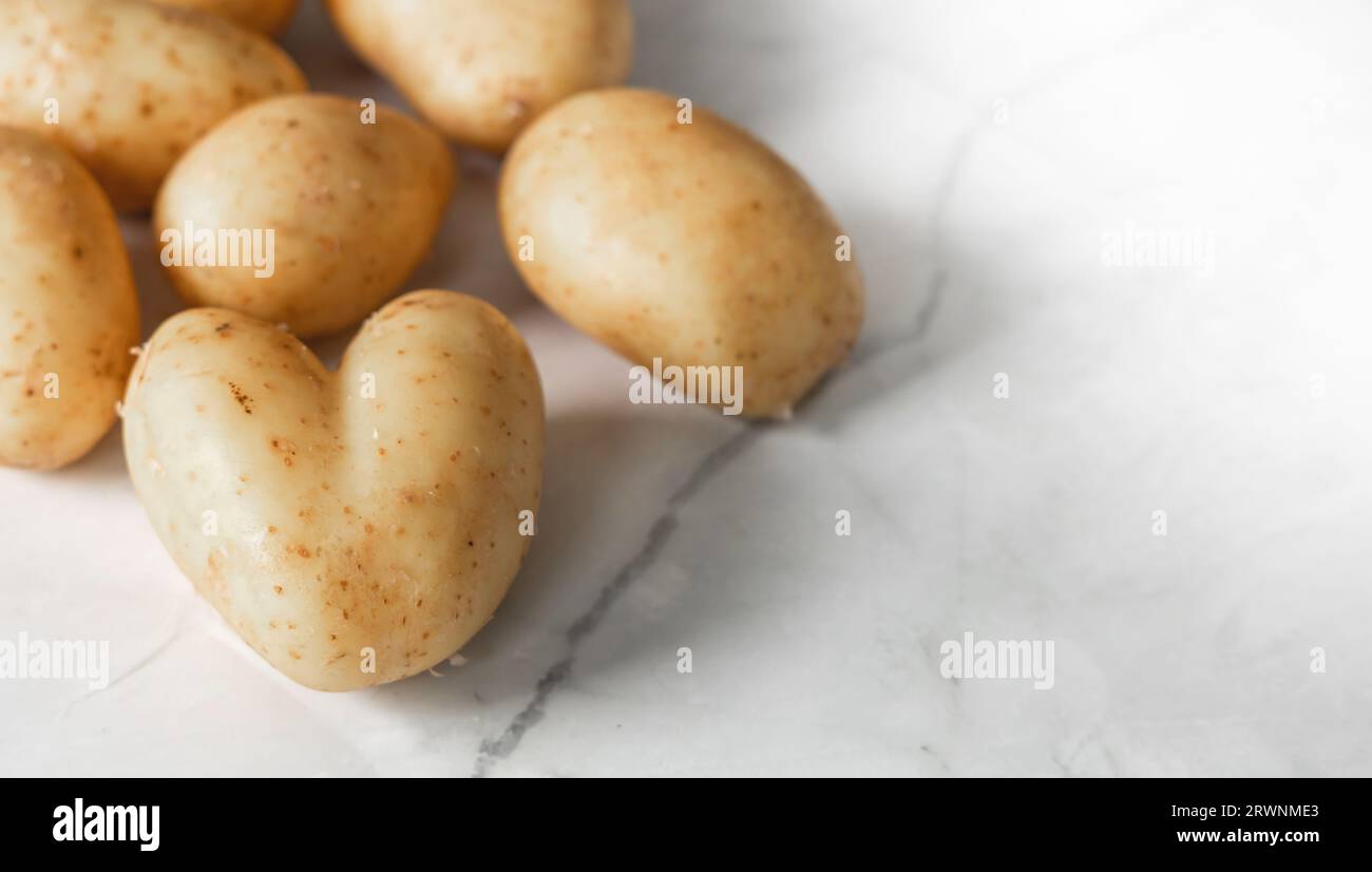 Heart shaped potatoes. A bunch of fresh potatoes Stock Photo - Alamy