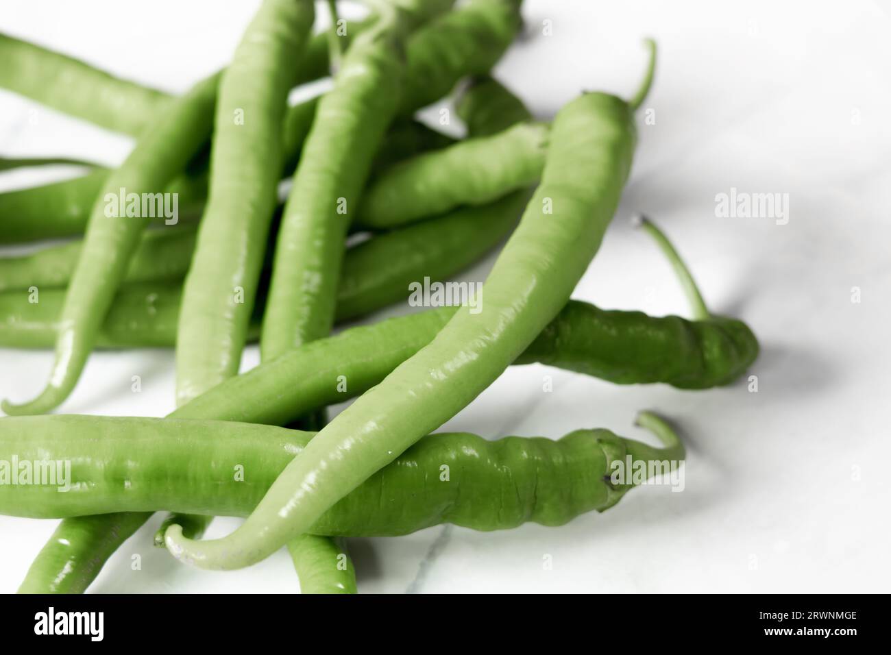 A bunch of green pepper pods. Hot chili pepper Stock Photo - Alamy