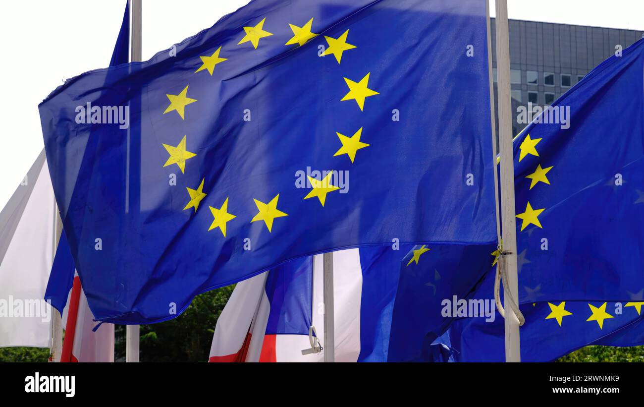 Flags of the European Union waving in the wind Stock Photo - Alamy