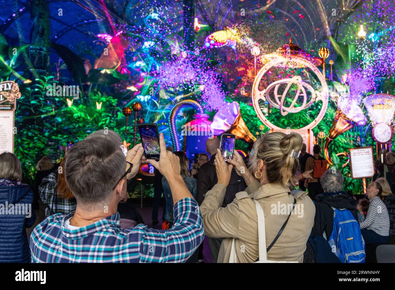 Visitors take pictures at the "The Butterfly Trail" event. Outernet ...