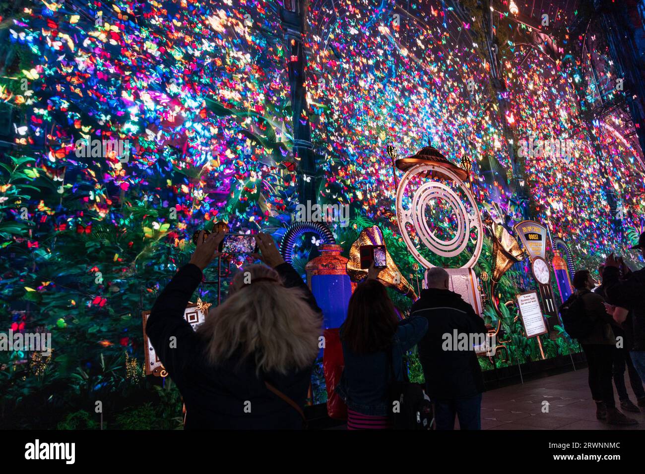 Visitors take pictures at the "The Butterfly Trail" event. Outernet ...