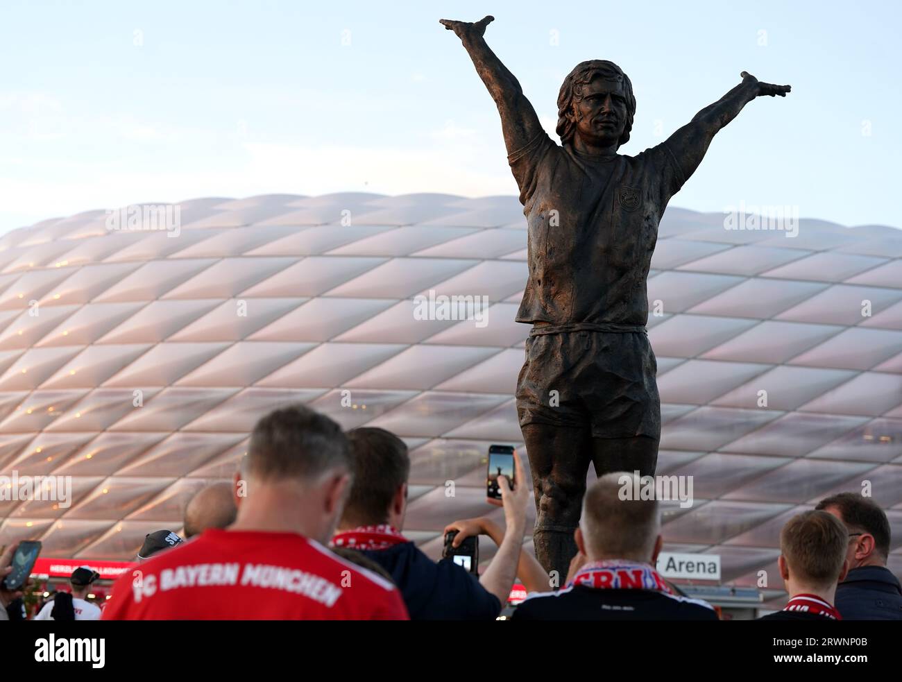 Bayern Munich fans next to the Gerd Muller statue outside the stadium ...