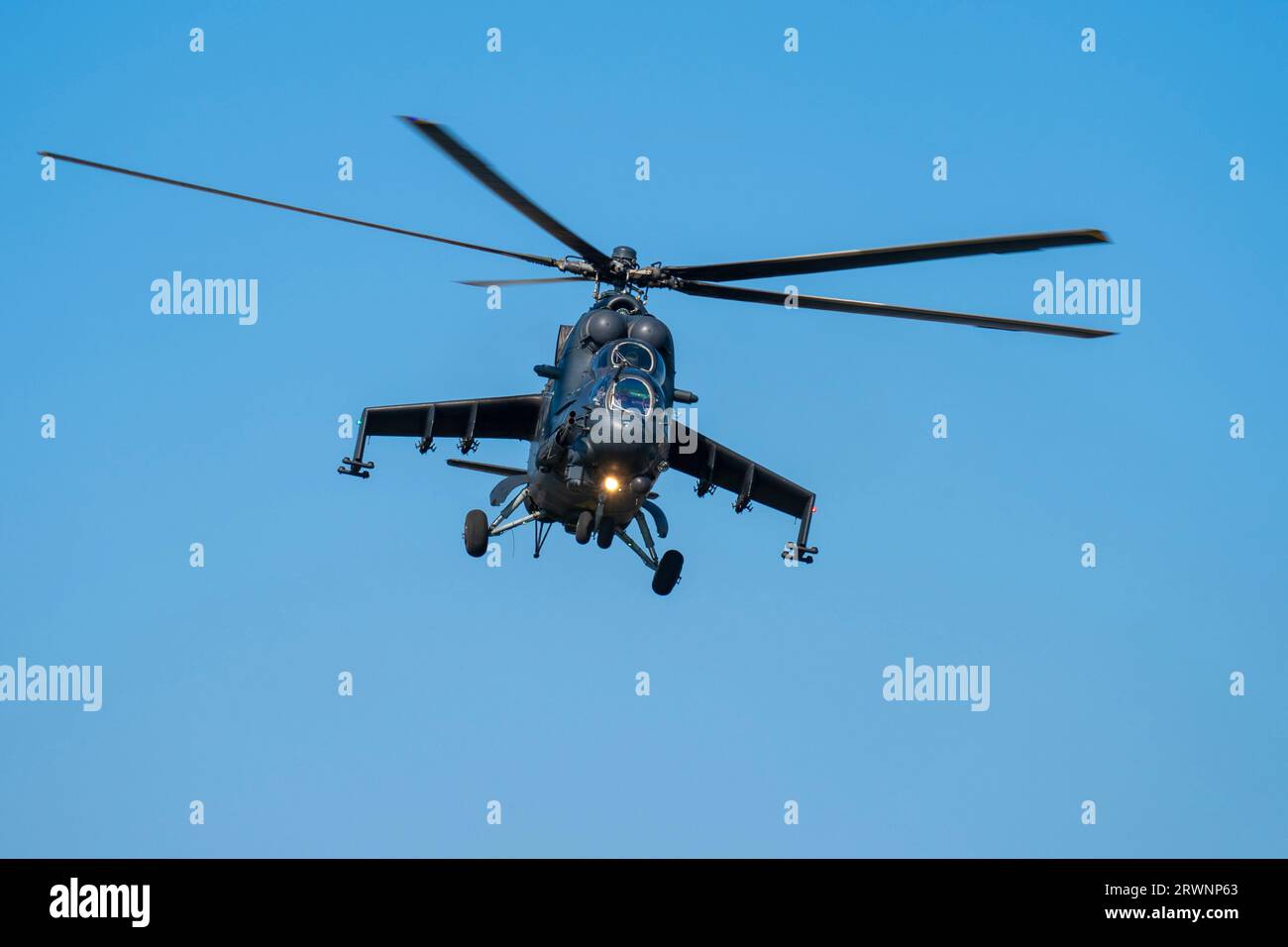 Soviet-made black Mi-24 military helicopter flying in the sky Stock ...