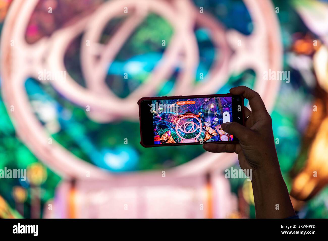 A visitor takes pictures at the "The Butterfly Trail" event. Outernet ...