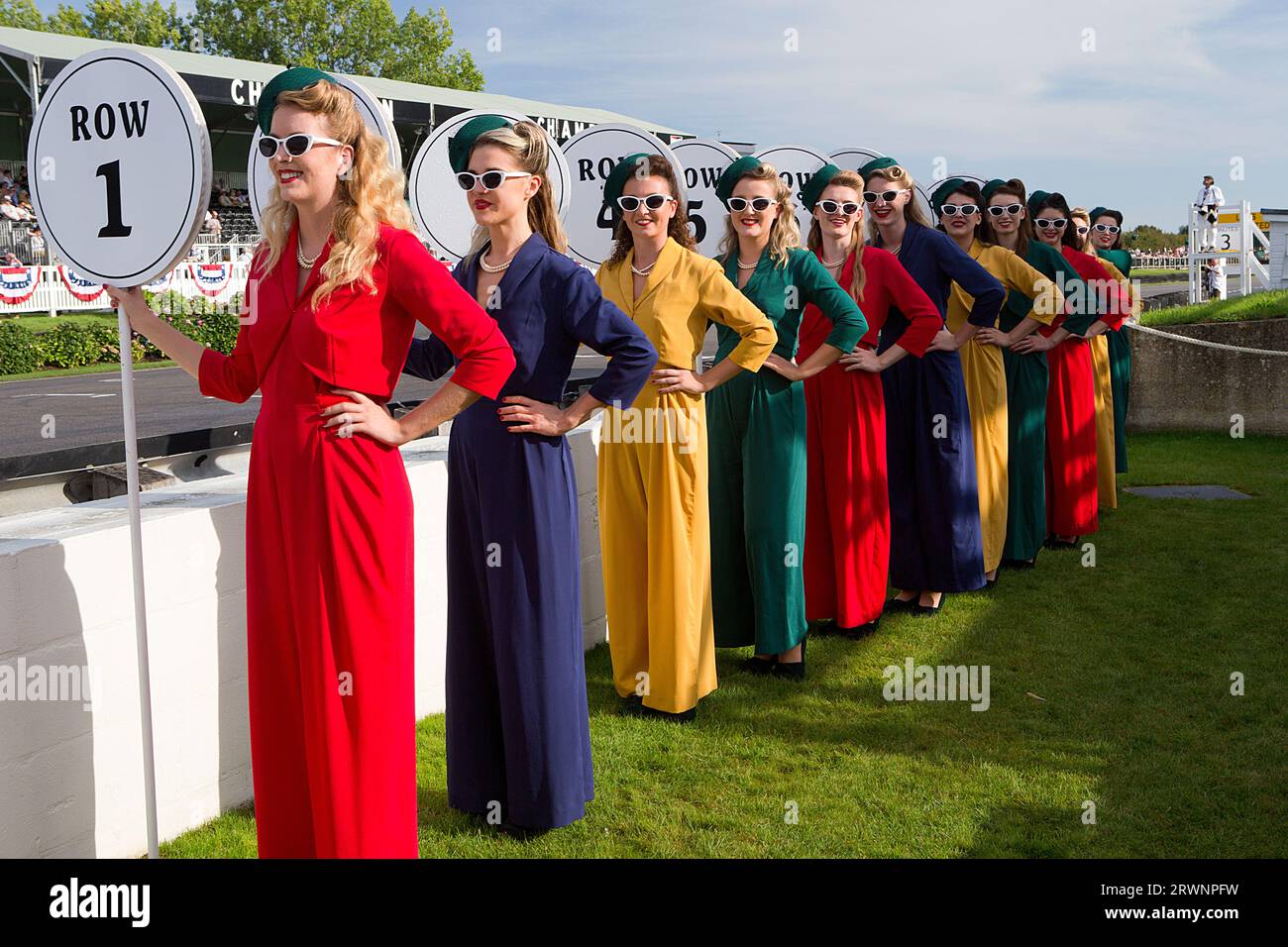 Grid Girls line up to enter the track at The Goodwood Revival Meeting ...