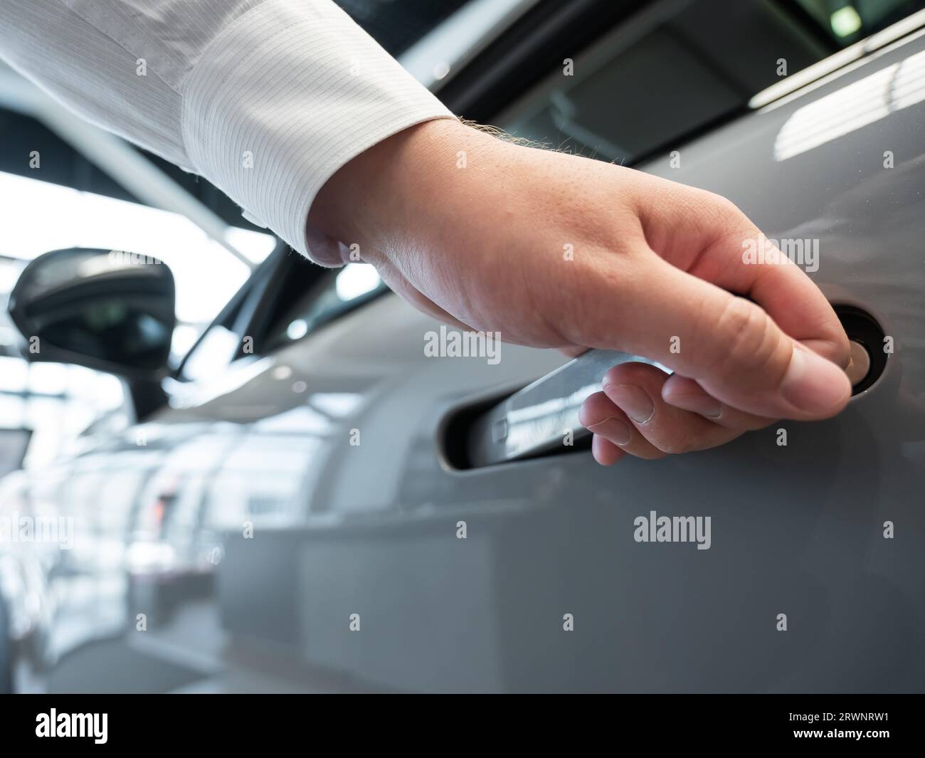 A man opens a car door with a fingerprint. Integrated handle Stock ...