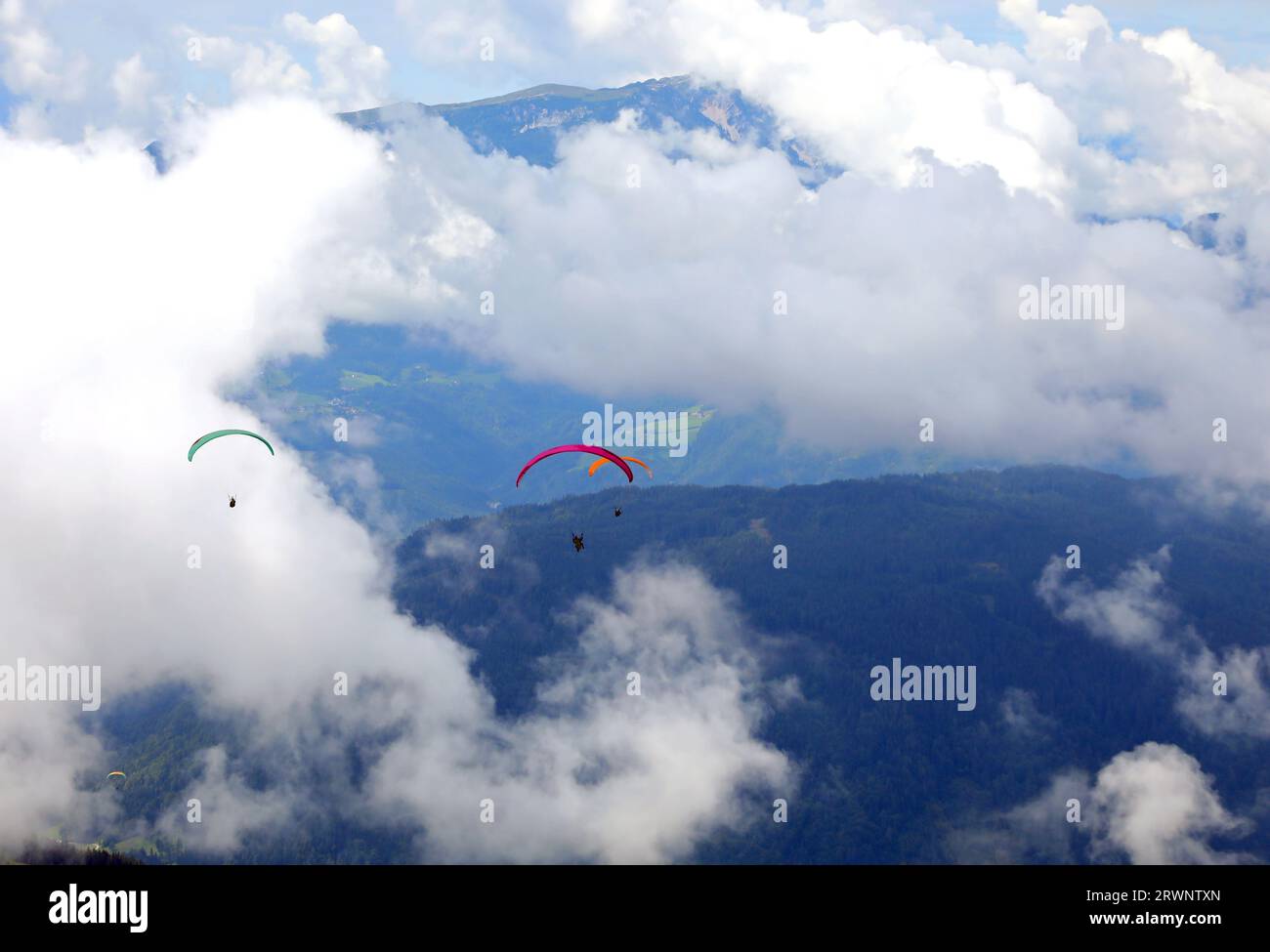 paragliding with two people on board for a couple flight and the clouds in the high mountains ...
