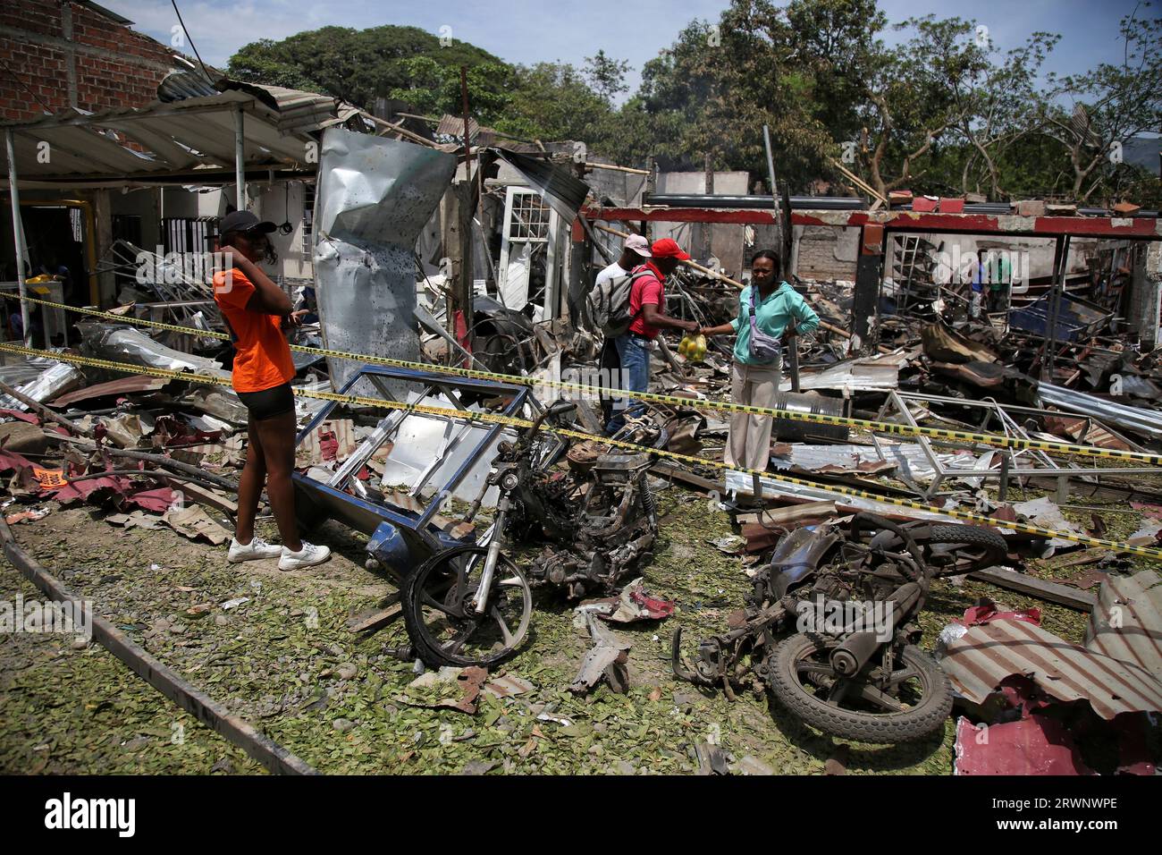 Debris from homes and a spare parts warehouse covers the ground after a ...