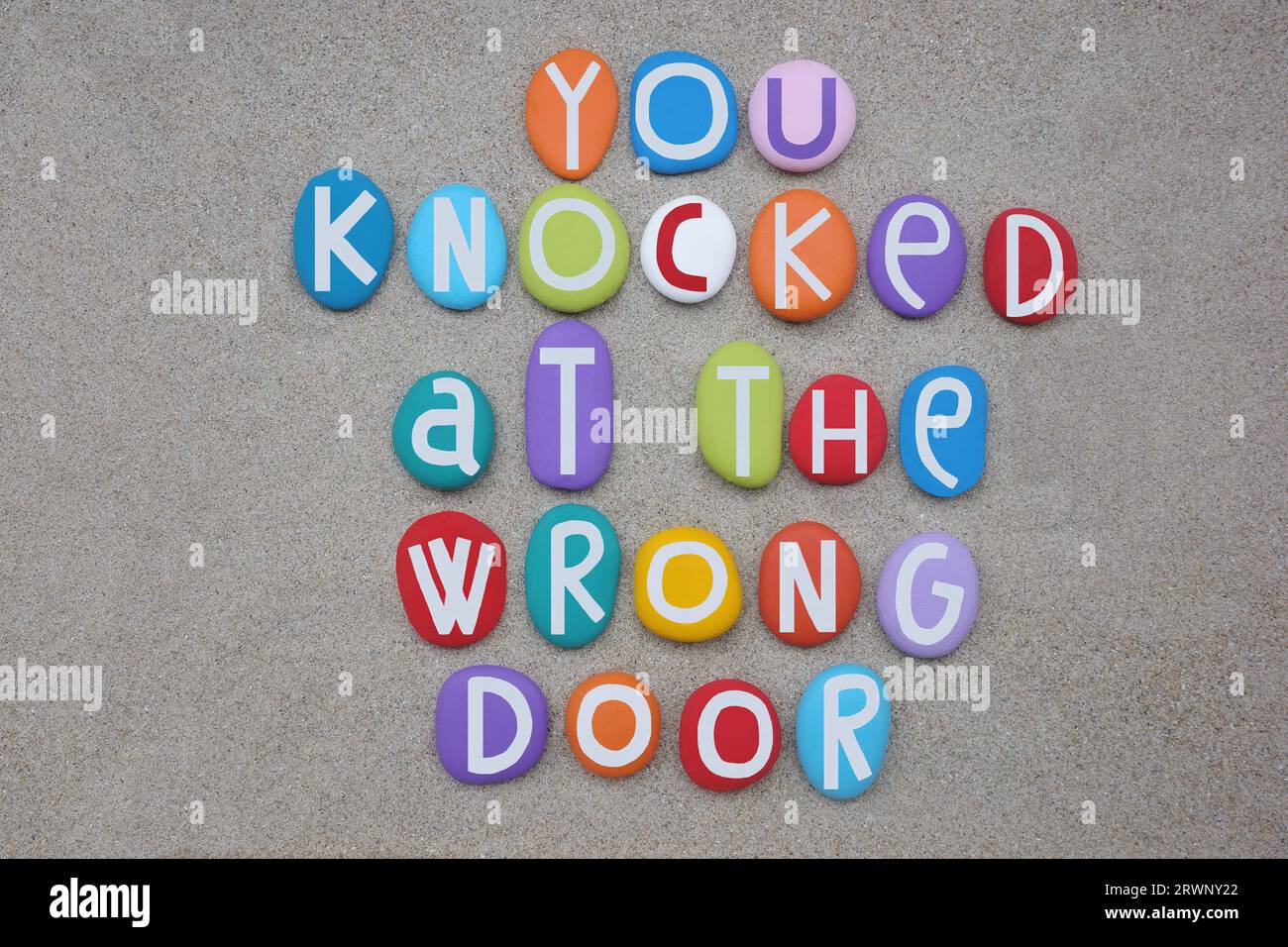 You knocked at the wrong door, creative text composed with hand painted multi colored stone ...