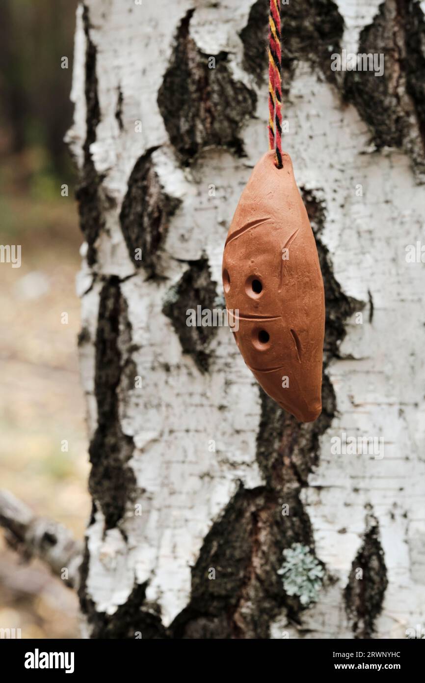 Ocarina, wind musical instrument suspended from birch branch Stock ...