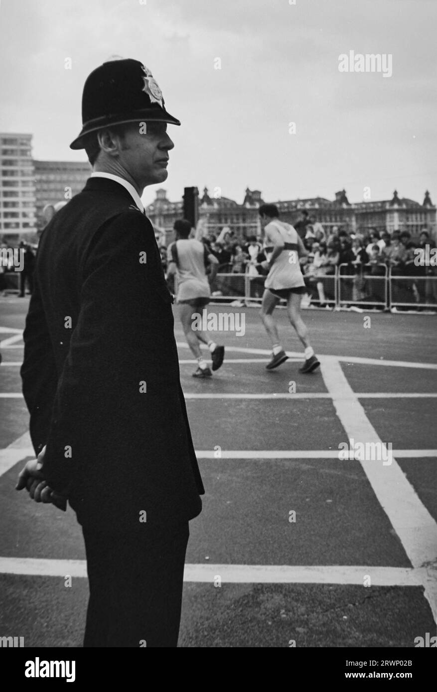 Policeman watches over the 1982 London Marathon Stock Photo - Alamy