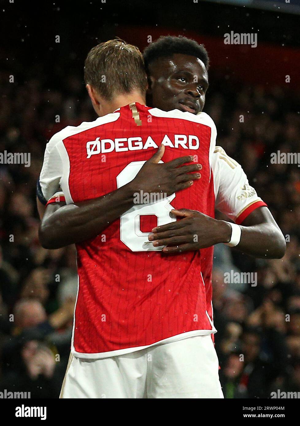 Arsenal's Bukayo Saka (right) celebrates with Martin Odegaard after ...