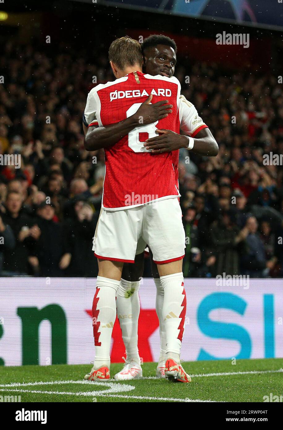 Arsenal's Bukayo Saka (right) celebrates with Martin Odegaard after ...