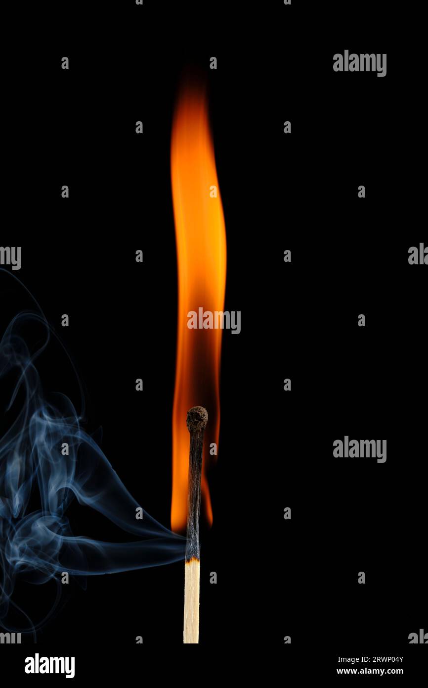 Burning match with smoke on black background Stock Photo - Alamy
