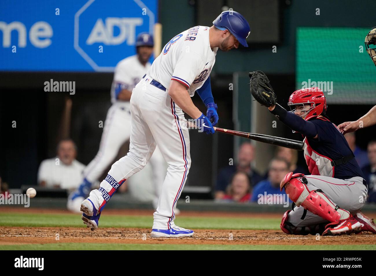 Texas Rangers' Mitch Garver, left, recoils from being hit by a pitch from Boston Red Sox pitcher ...
