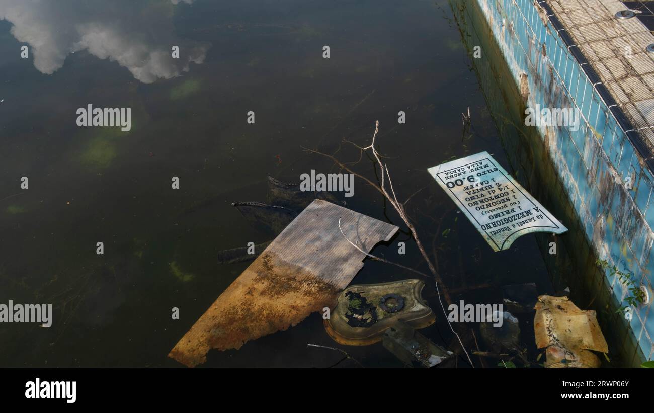 Old swimming pool center full of trash, rubbish, overgrown facility in ...