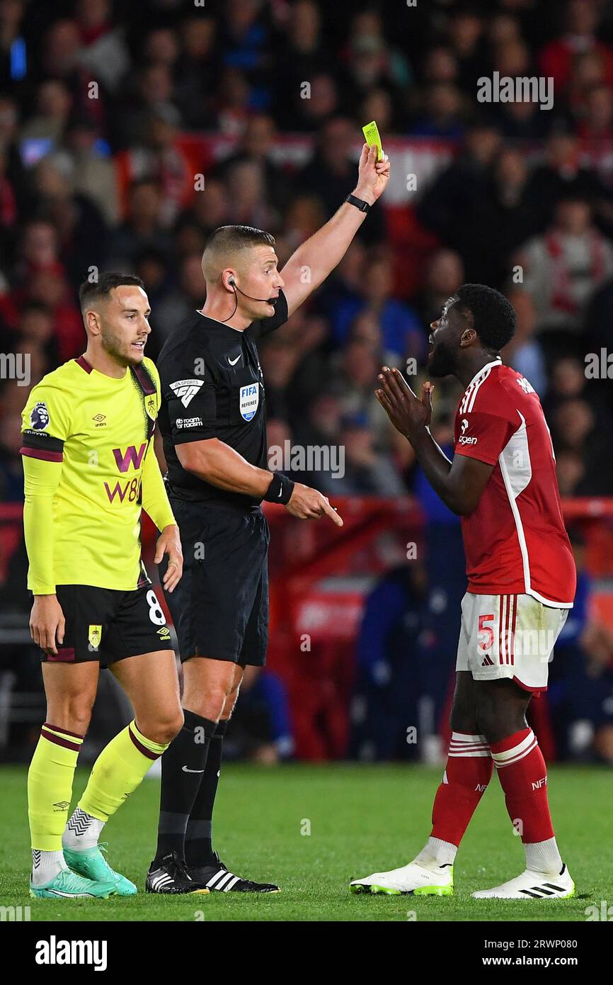 Referee, Robert Jones shows a yellow card for unsporting behaviour to ...