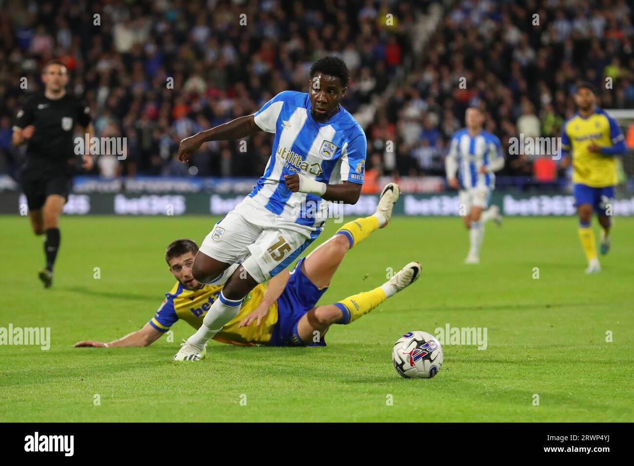 Jaheim Headley #15 of Huddersfield Town gets passed Lynden Gooch #2 of ...