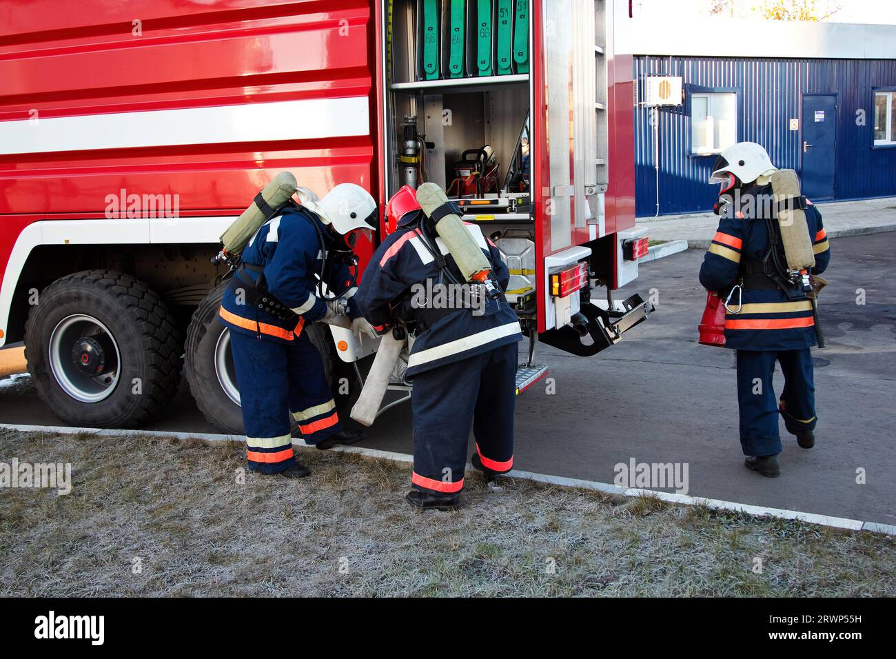 Group of firemen putting on gas masks and preparing for extinguish fire ...