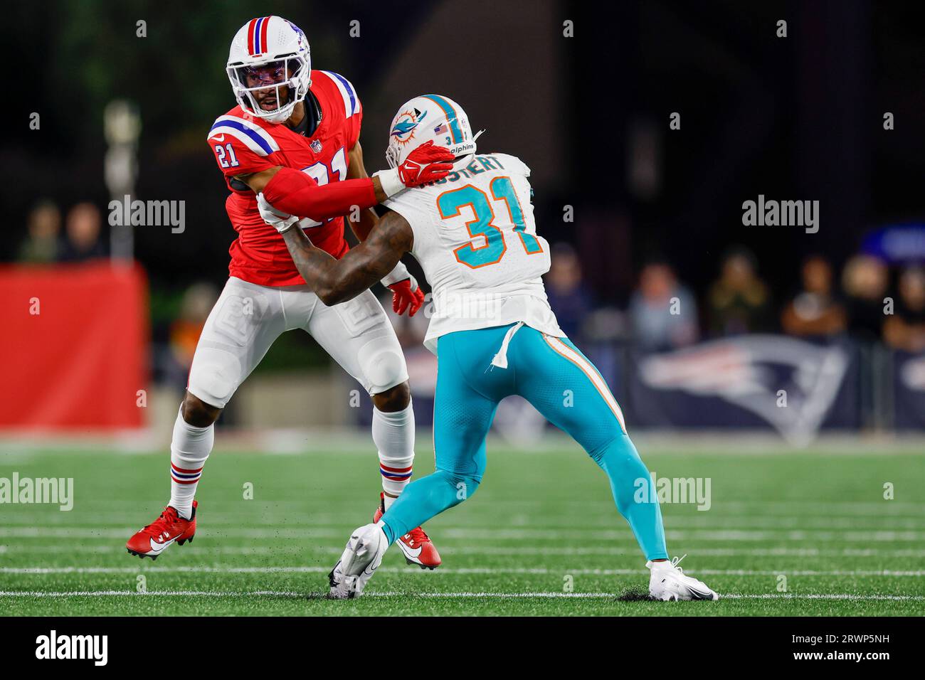 New England Patriots safety Adrian Phillips (21) battles with Miami Dolphins running back Raheem ...