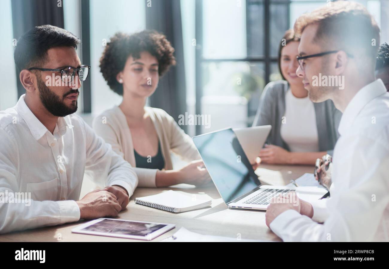 Employees working at computer together, discussing content Stock Photo ...