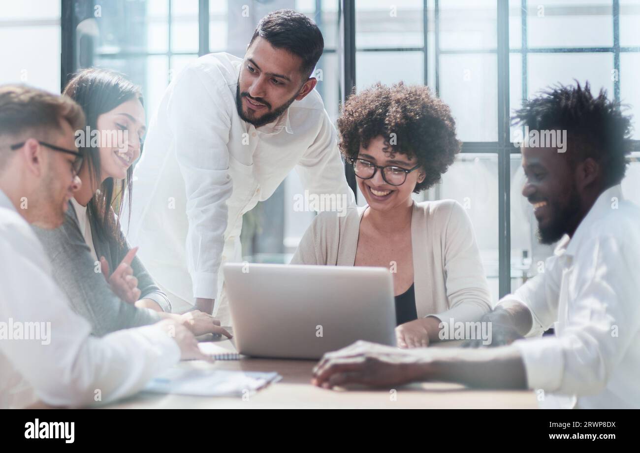 Employees working at computer together, discussing content Stock Photo ...