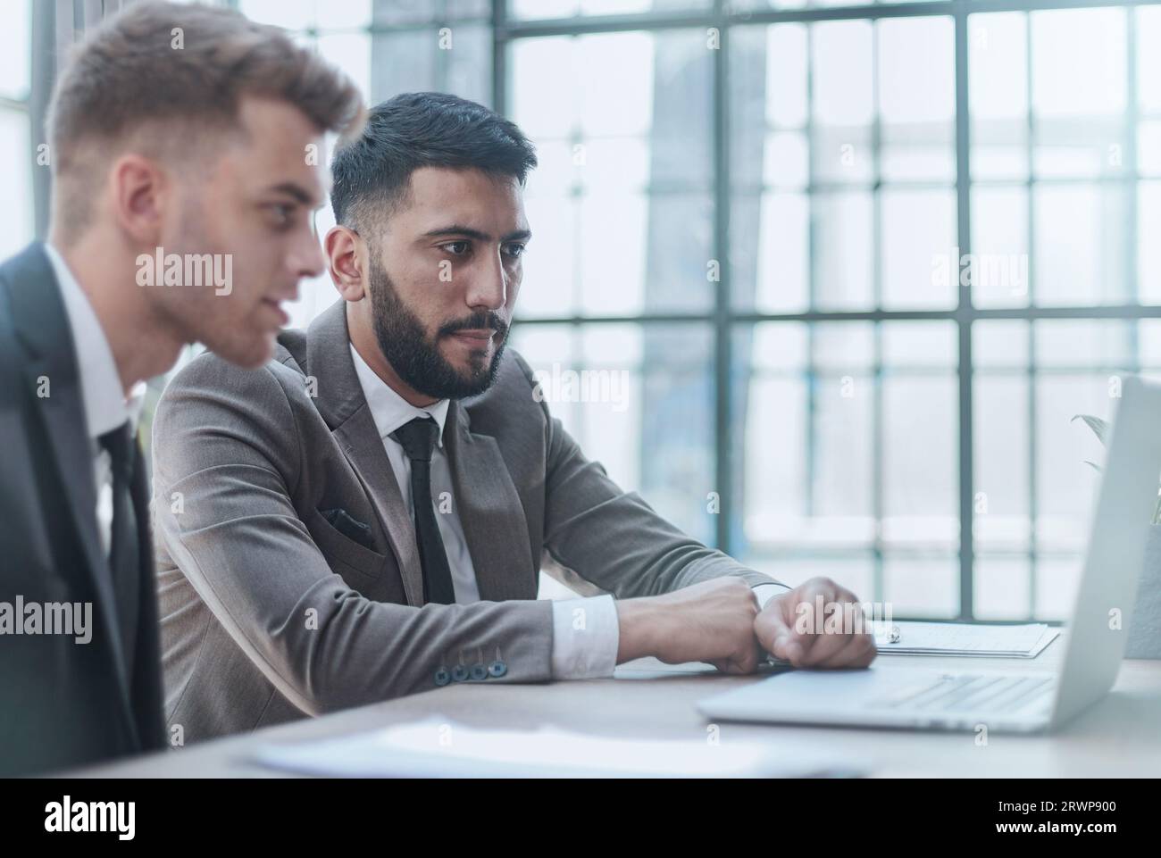Two happy men working together on a new business project Stock Photo ...