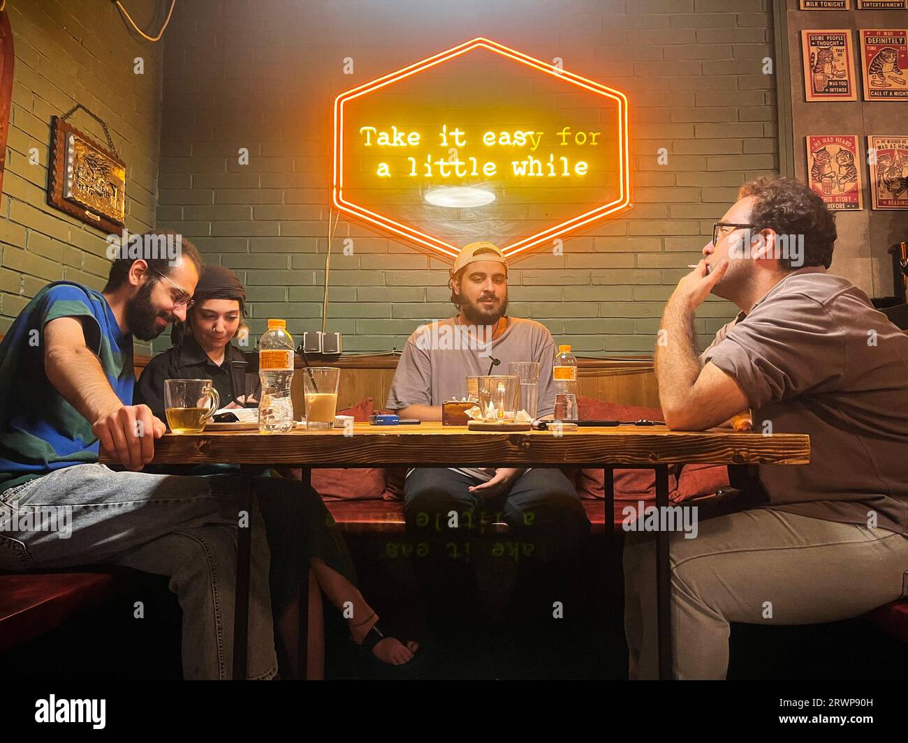 Tehran, Iran. 18th Sep, 2023. Four Iranian youth spend their time in a ...