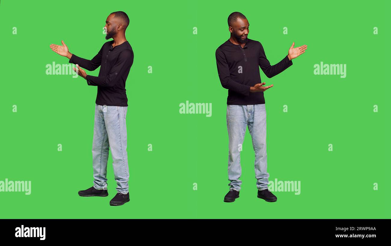 African american man creating advertisement in studio, pointing to left ...