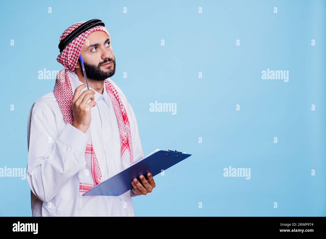 Pensive man wearing traditional muslim clothes thinking while taking ...