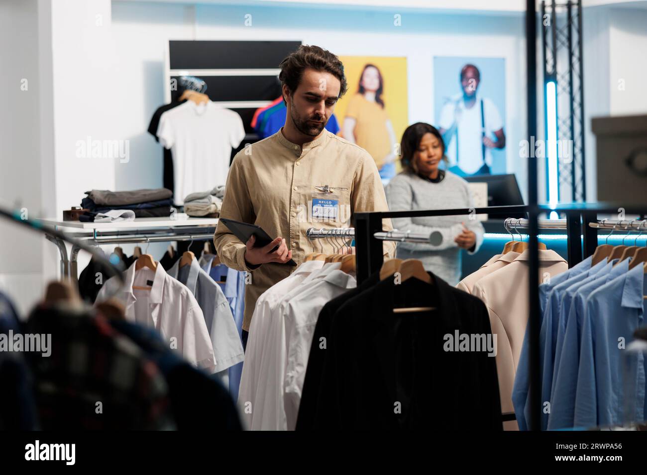 Clothing store employee examining hi-res stock photography and images ...