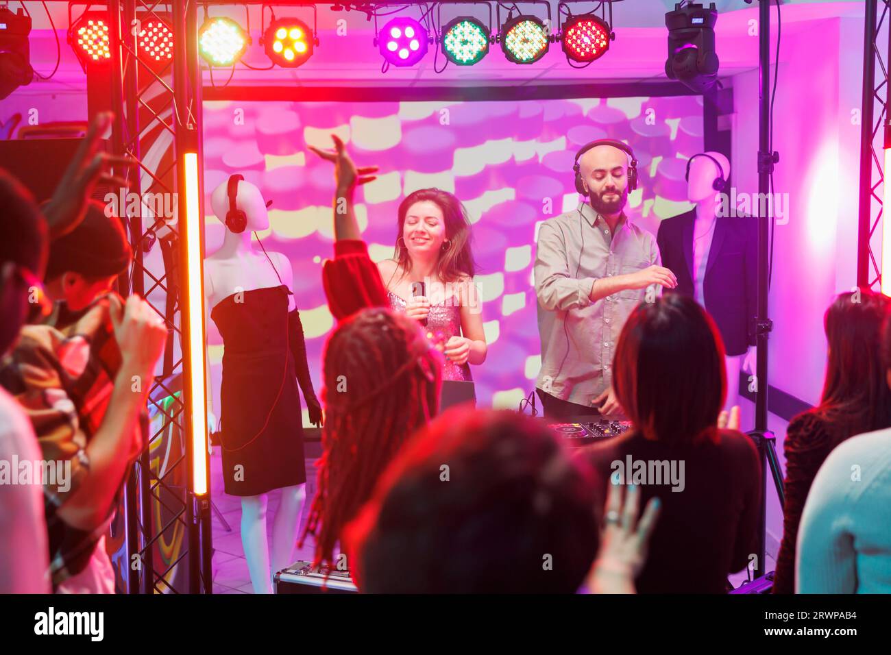 Man and woman musicians playing and singing on stage at electronic ...