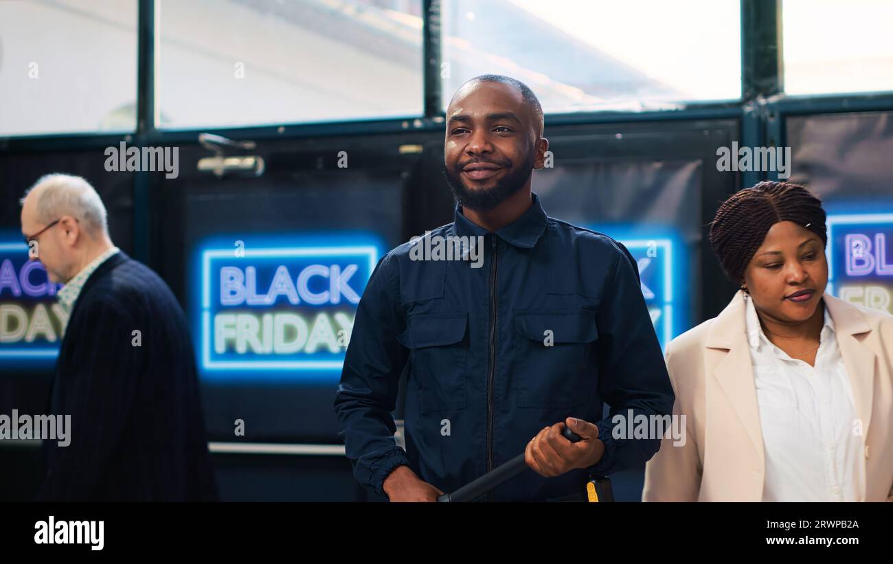 Security guard in clothing store wearing uniform and presenting on duty ...