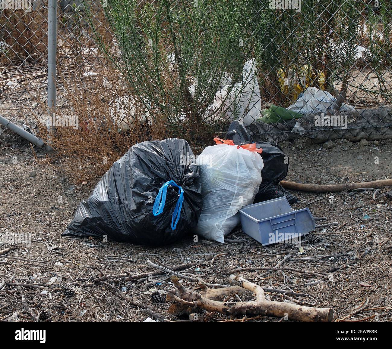 plastic bags of trash dumped along the 880 freeway at the Alameda Creek ...