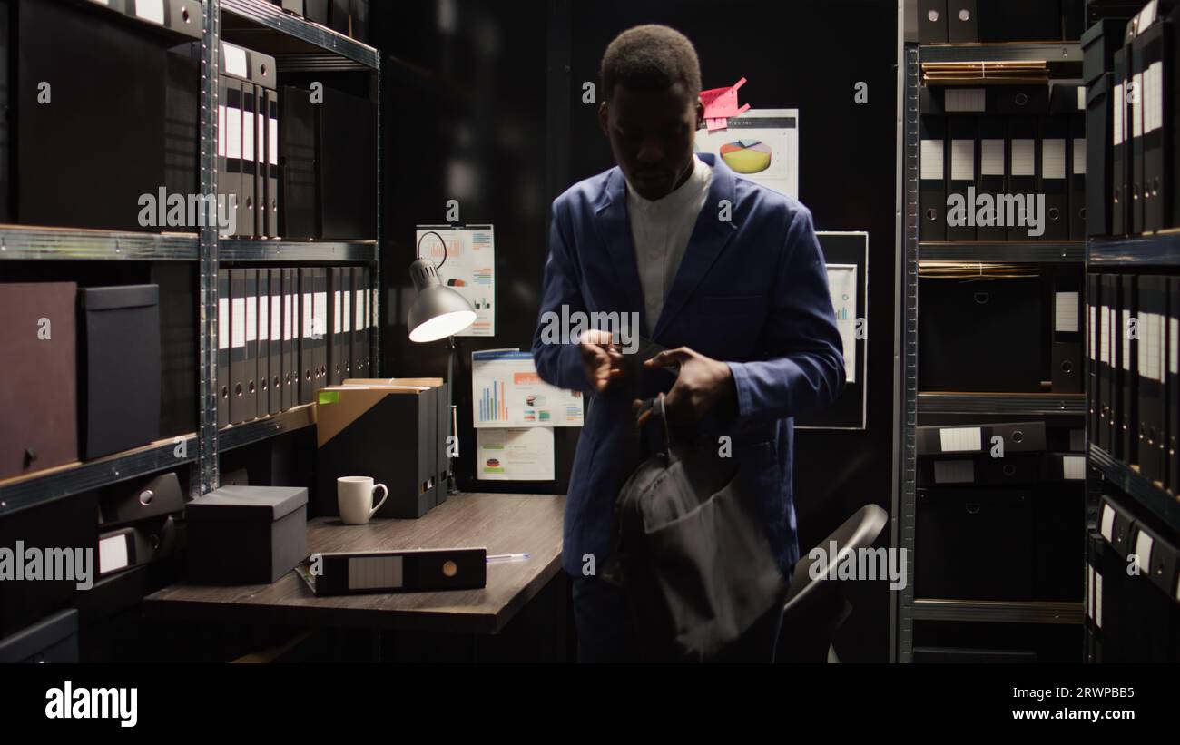 Exiting the evidence room, male private detective closes his personal ...