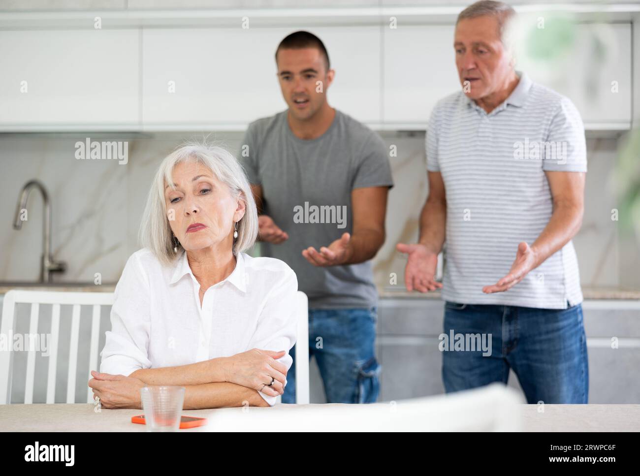 Adult woman thinks how to resolve conflict with her husband and son ...